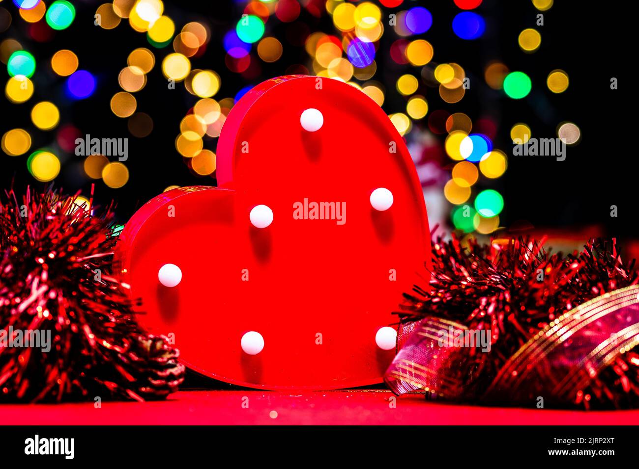 The Christmas heart-shaped decoration and ornaments on a blurred lights ...