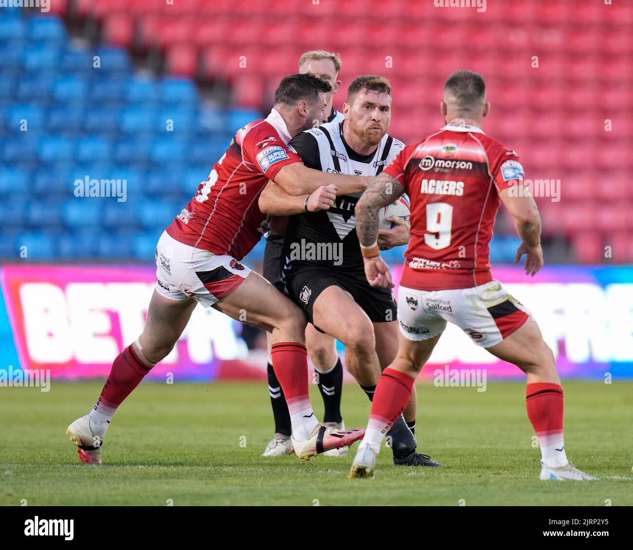 Deon Cross #28 of Salford Red Devils tackles Scott Taylor #30 of Hull ...