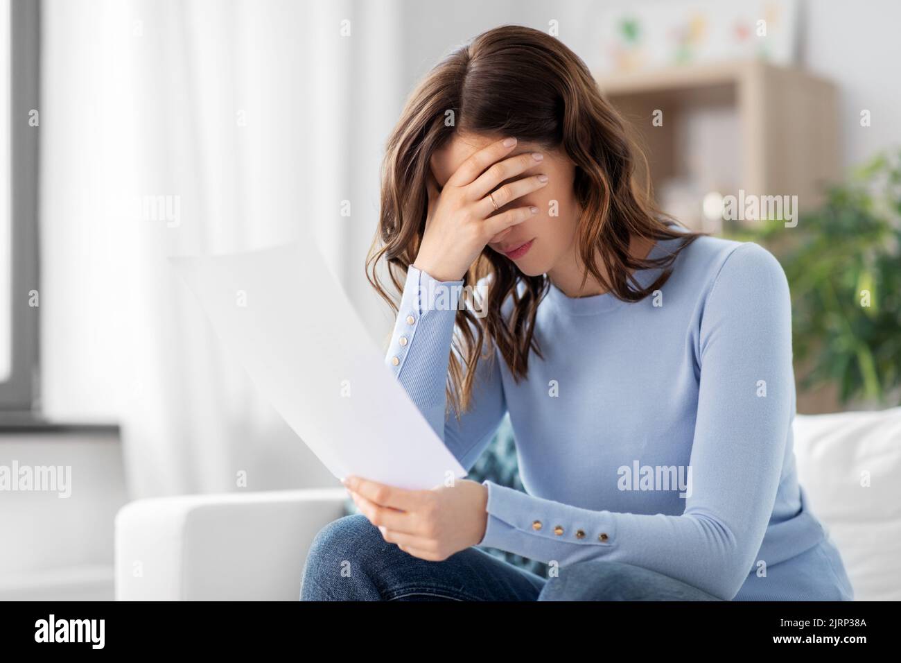 stressed woman with paper sheet at home Stock Photo - Alamy