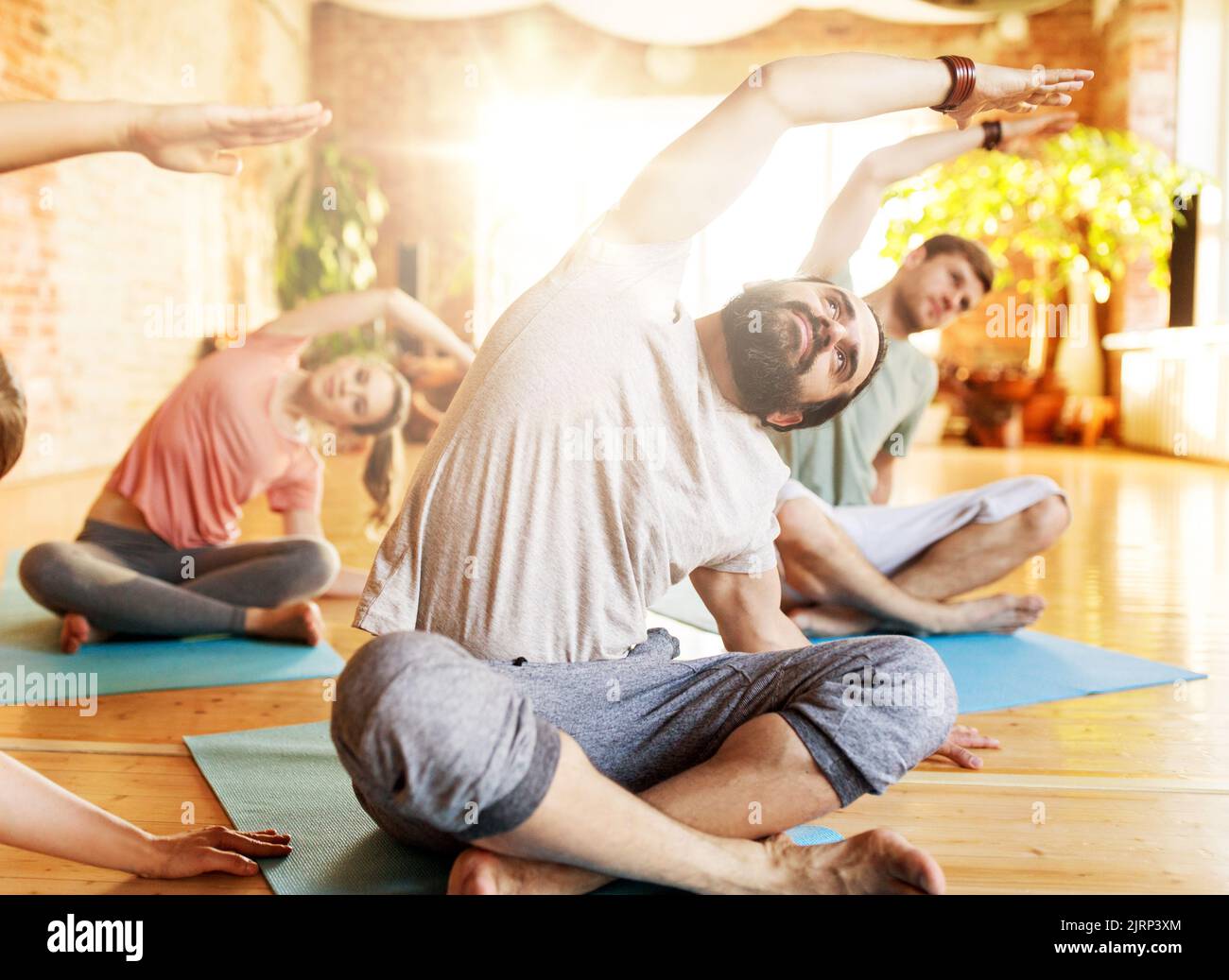 group of people doing yoga exercises at studio Stock Photo - Alamy