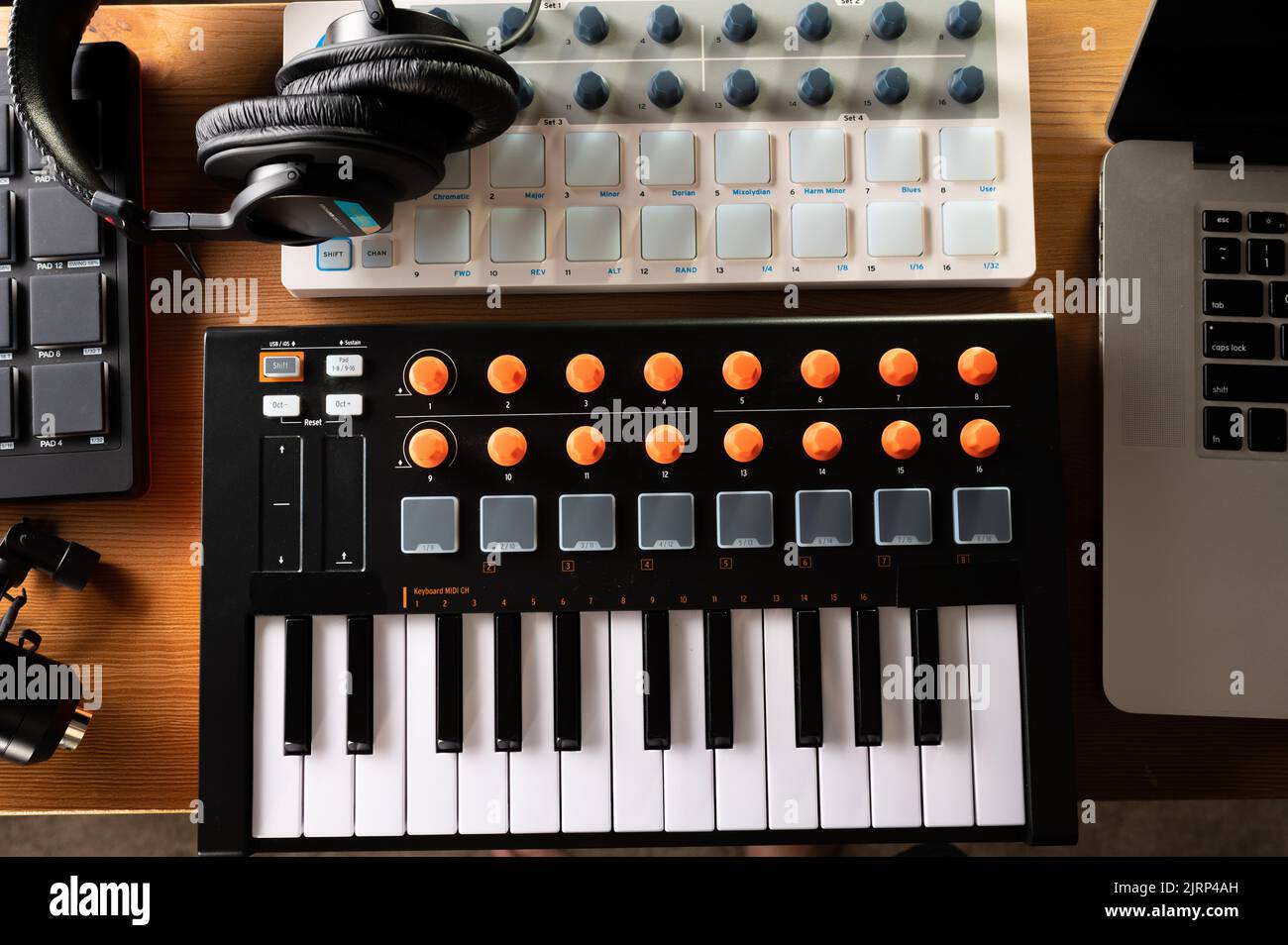 Close-up. MIDI keyboard and studio headphones. Technological background ...