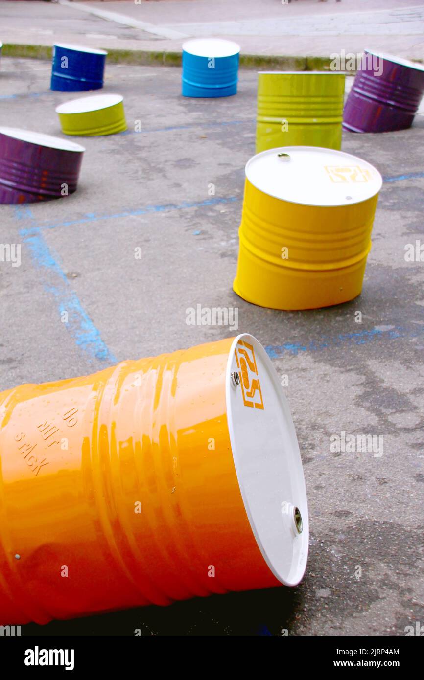 Artistic installation of colorful metal barrels that rest and intersect ...