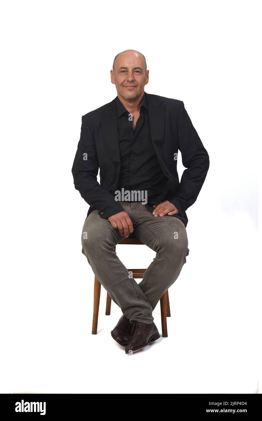 front view of a full portrait of a man sitting on chair on white ...