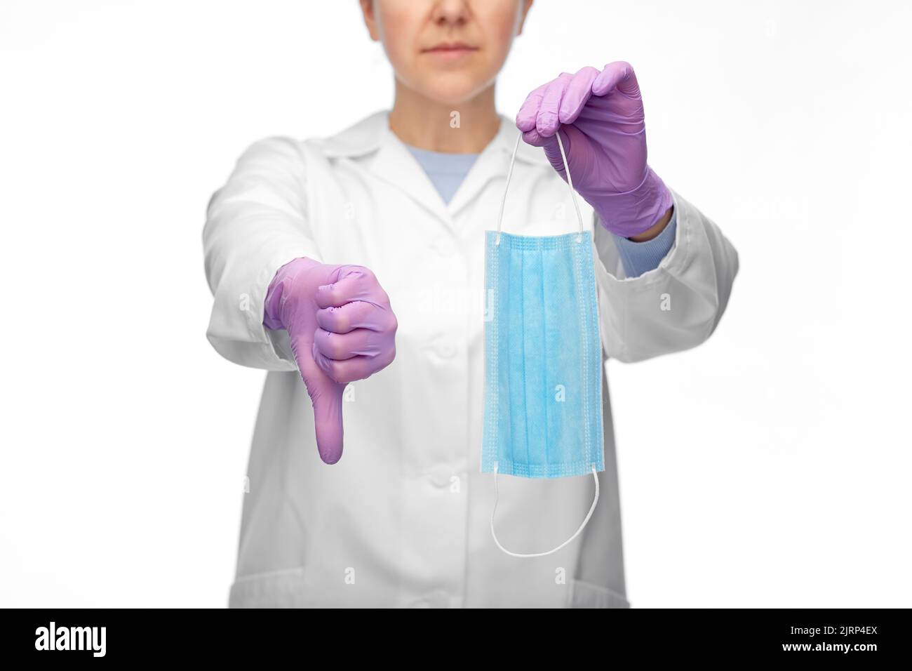 female doctor with mask showing thumbs down Stock Photo - Alamy