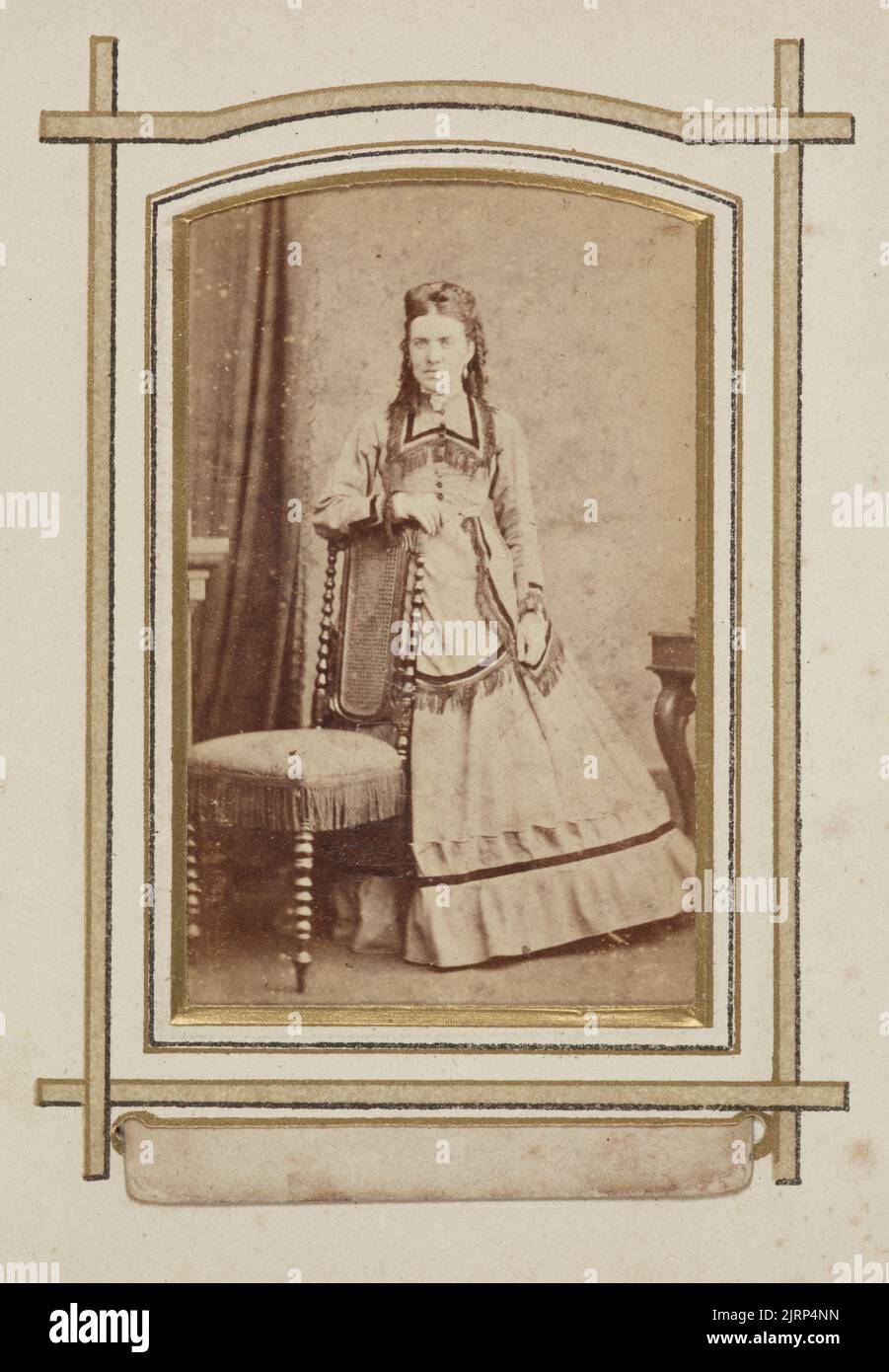 Portrait of a young woman leaning against chair hi-res stock ...