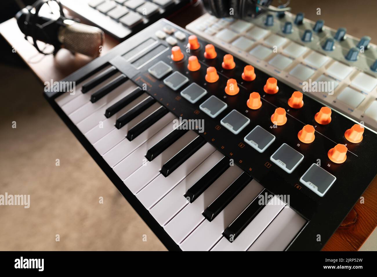 Studio equipment - midi keyboard, headphones and microphone. Recording ...