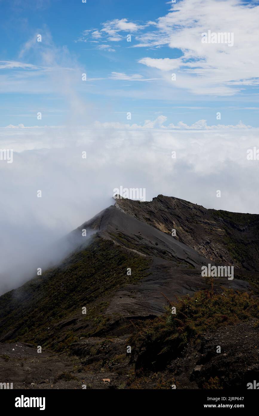 A vertical shot of beautiful Volcano Irazu and cloudscape in Costa Rica ...