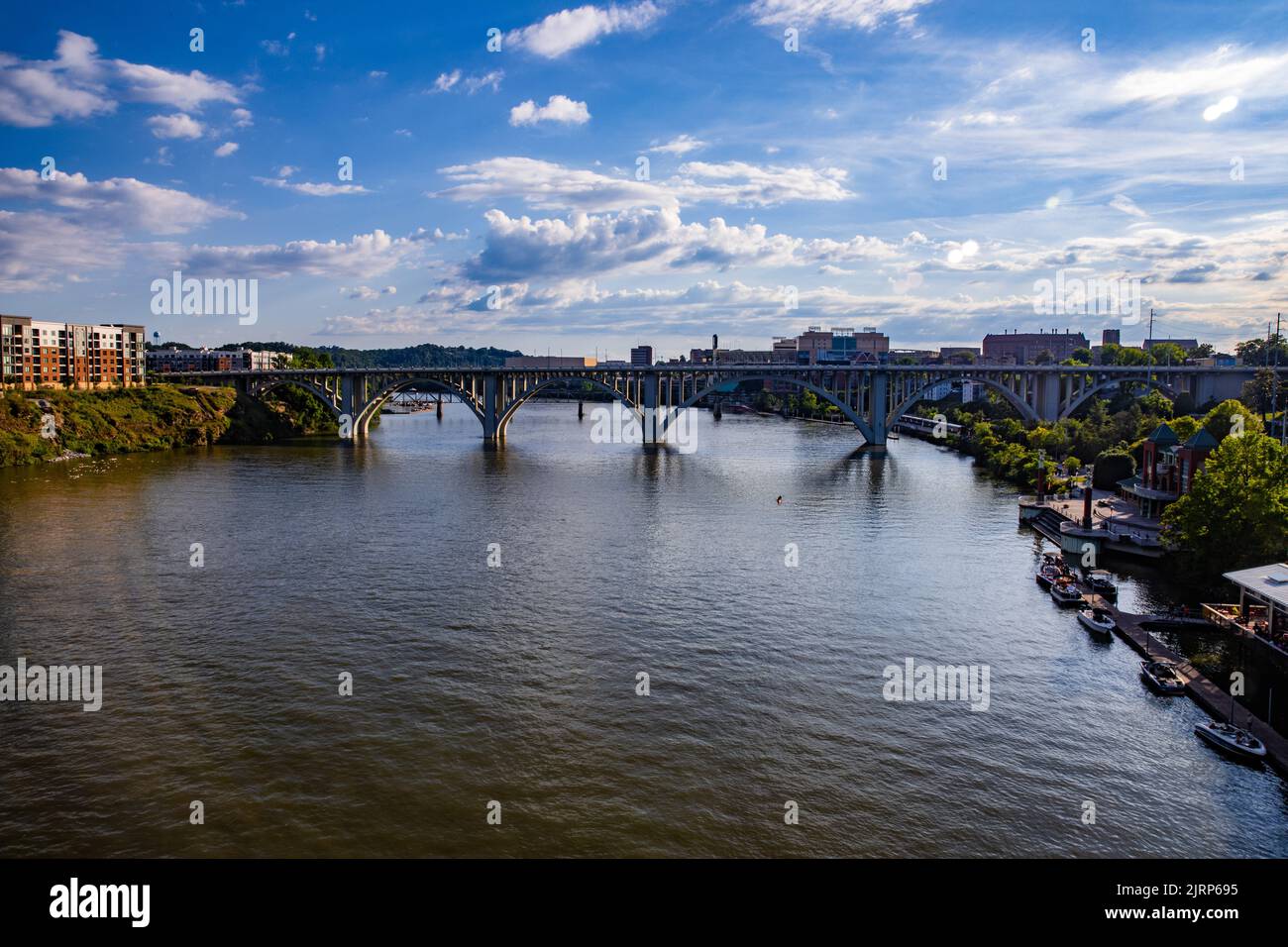 An old bridge on a big river flowing through the city Stock Photo - Alamy