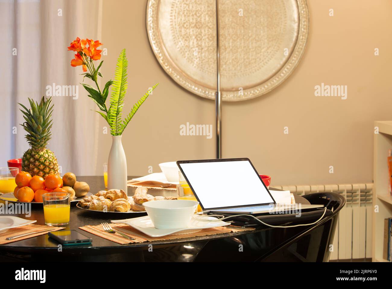 Design dining table in dark wood with breakfast service with fruits and ...