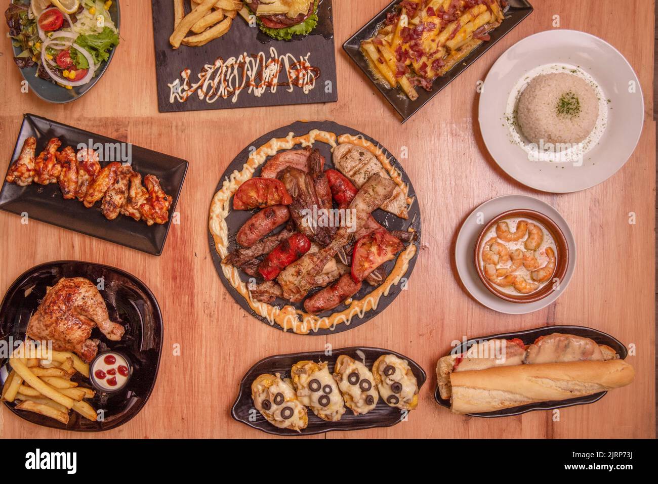 Set of plates of food cooked in the oven with a central tray of ...