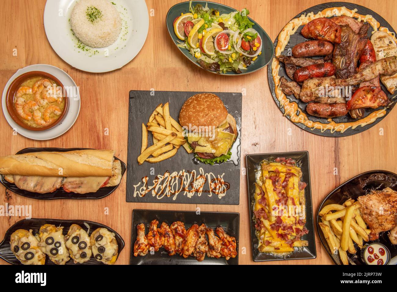 Set of plates of food cooked in the oven with a central tray of ...