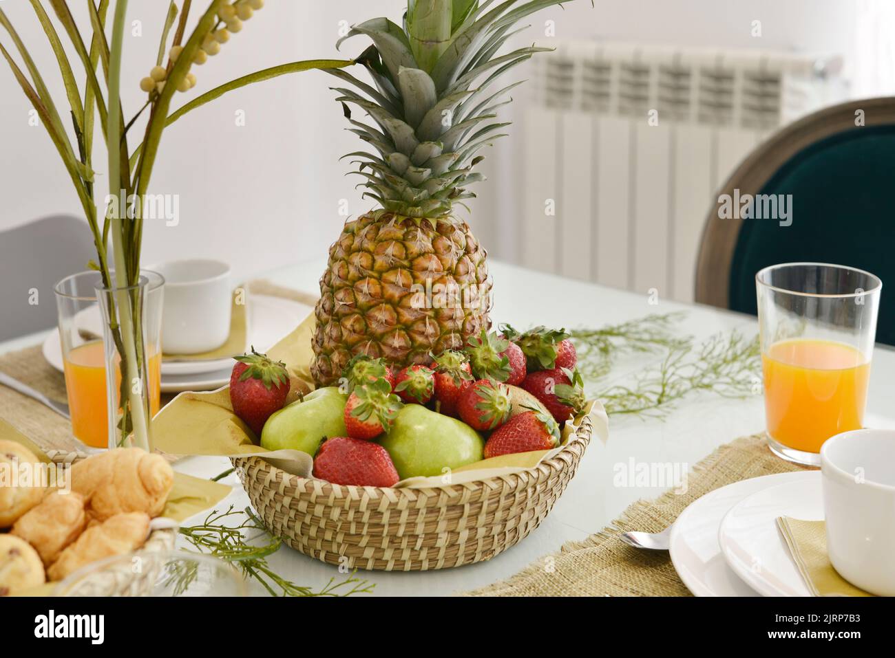 Corner of a kitchen with a white wooden countertop with a wicker basket ...