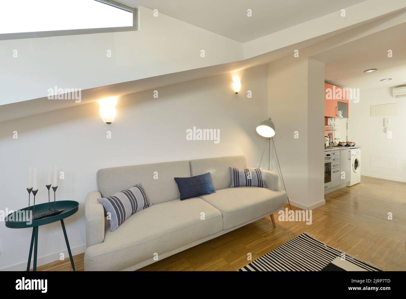 Living room in studio apartment with three-seater fabric sofa ...