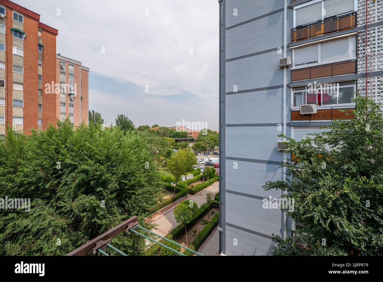 Views of urban residential buildings with lots of trees between block ...