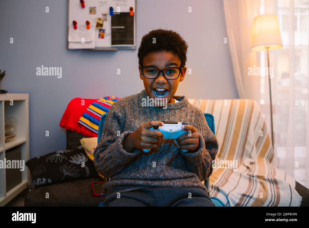 Black boy screaming while using joystick while playing online game at ...