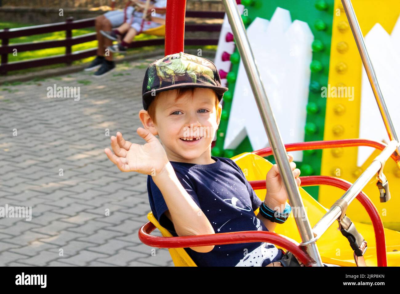 a little boy on a carousel waves his hand Stock Photo - Alamy