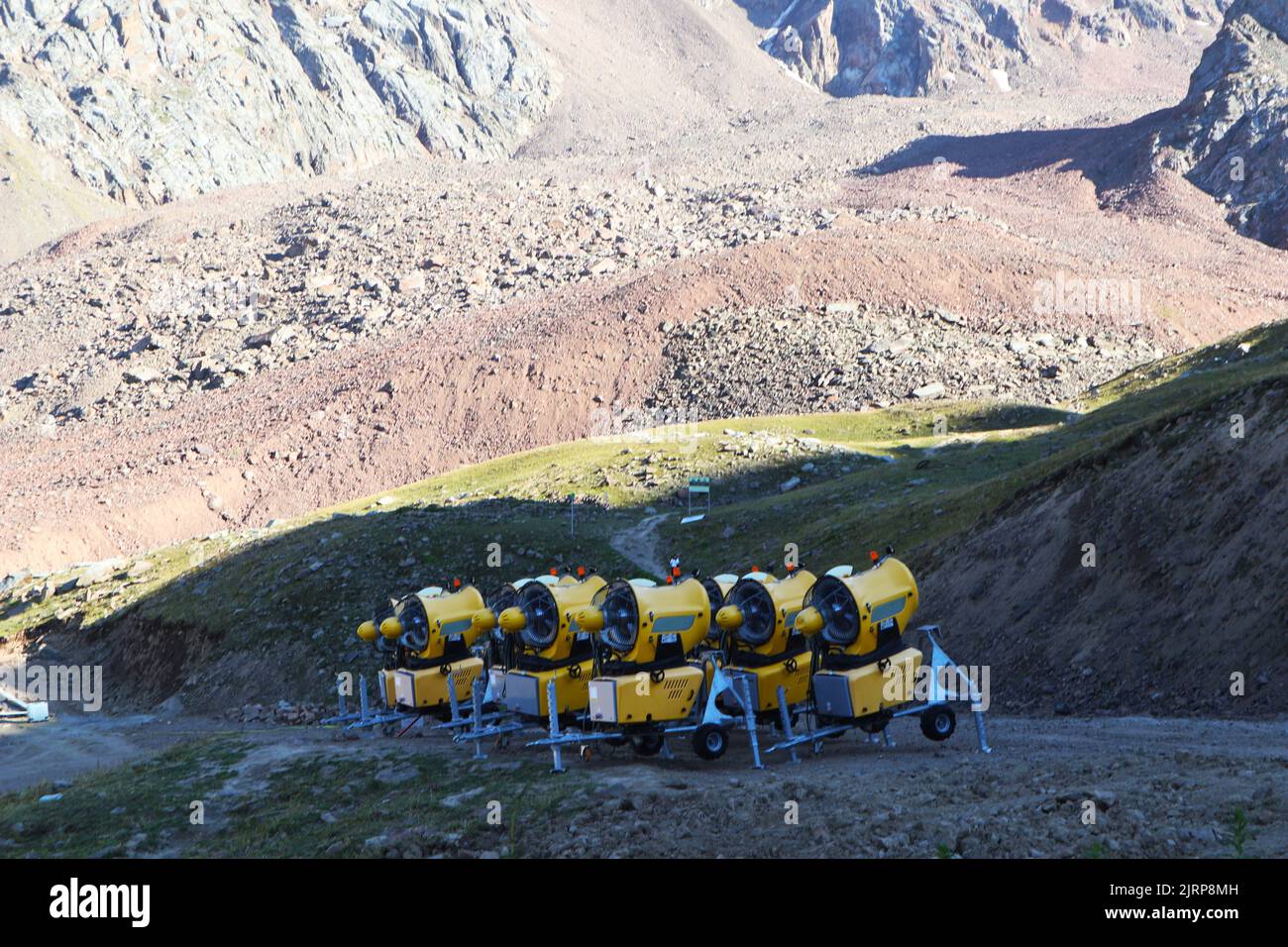 yellow snow cannons on the mountainside. top of the mountain Stock ...