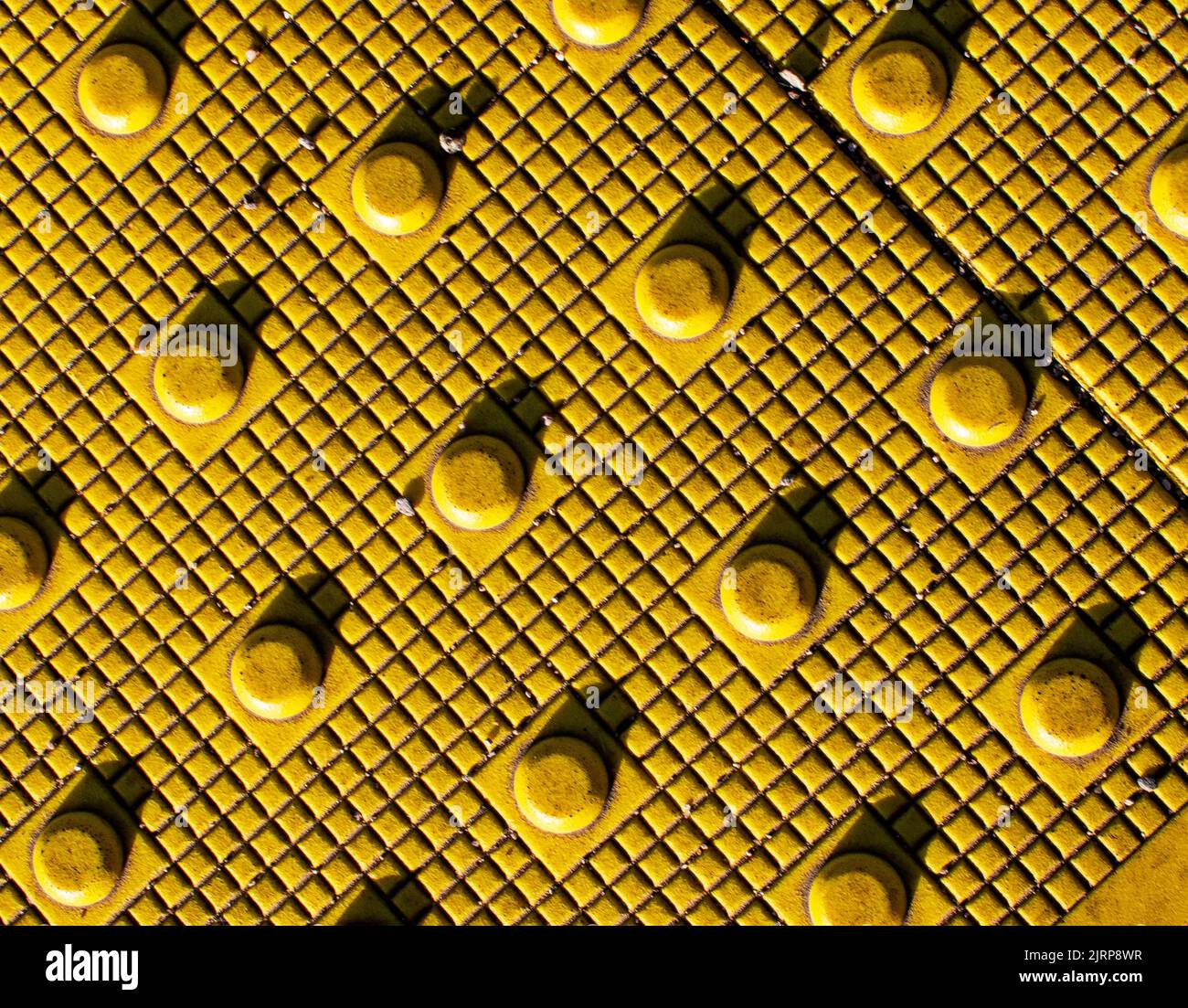 Yellow rubber flooring on rail station for blind and partially sighted ...