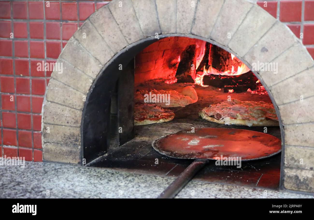 Pizza baked in a wood-fired oven Stock Photo - Alamy