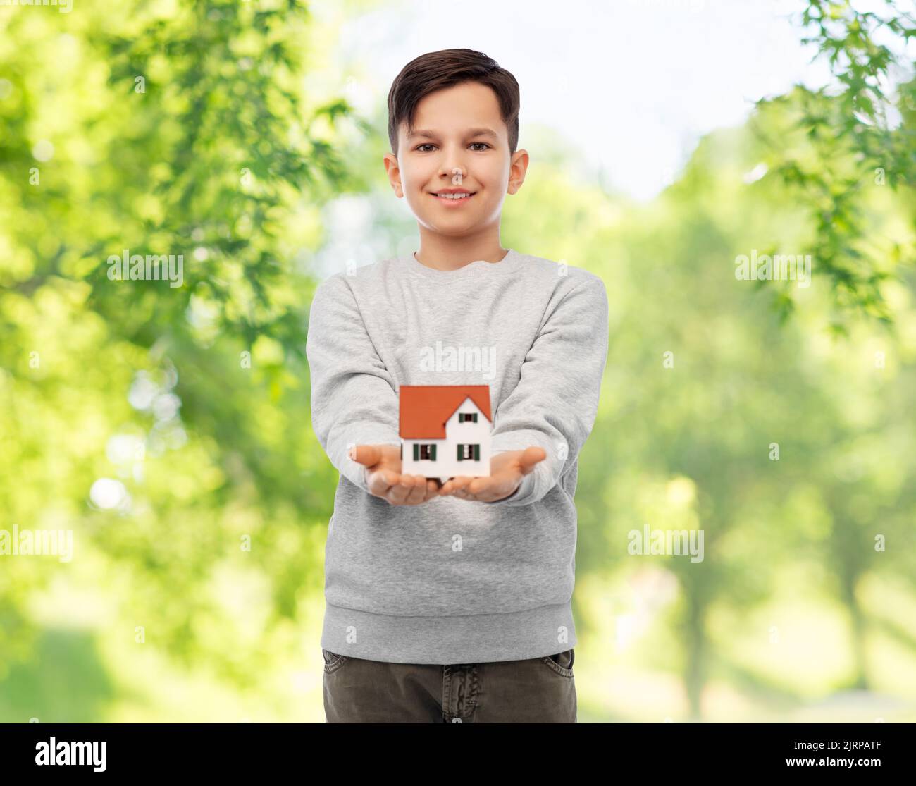 smiling boy holding house model Stock Photo - Alamy