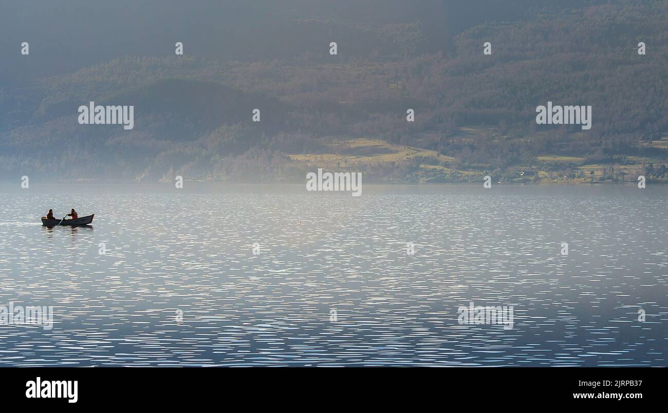 boat sailing on a lake with fog Stock Photo - Alamy