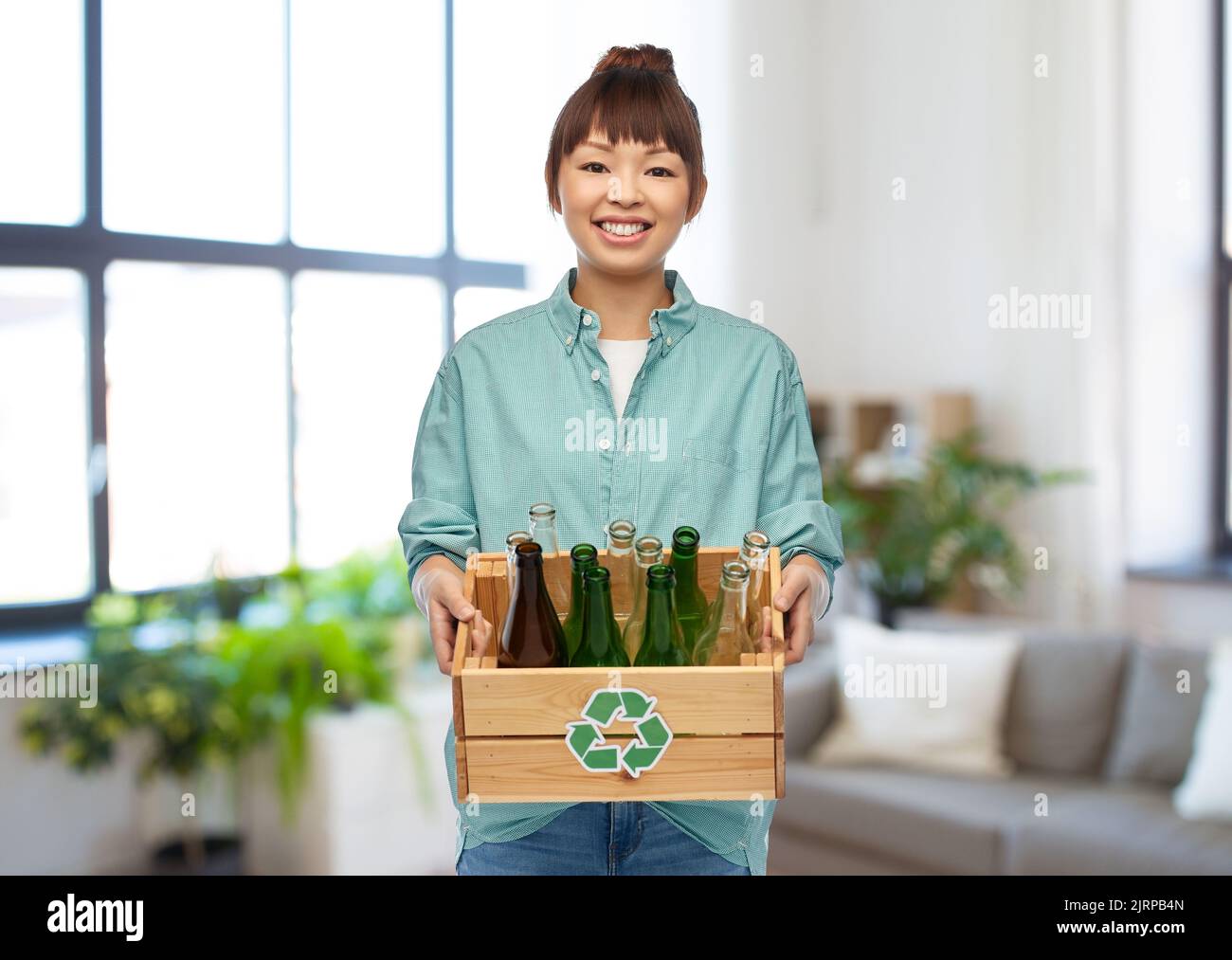 smiling young asian woman sorting glass waste Stock Photo - Alamy