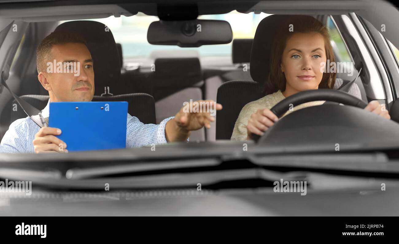 car driving school instructor and young driver Stock Photo - Alamy