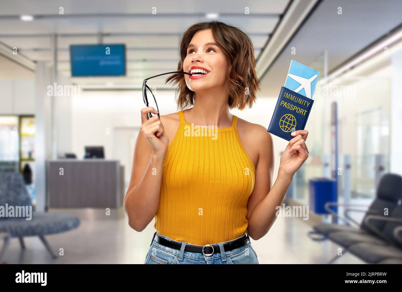 happy woman with air ticket and immunity passport Stock Photo - Alamy