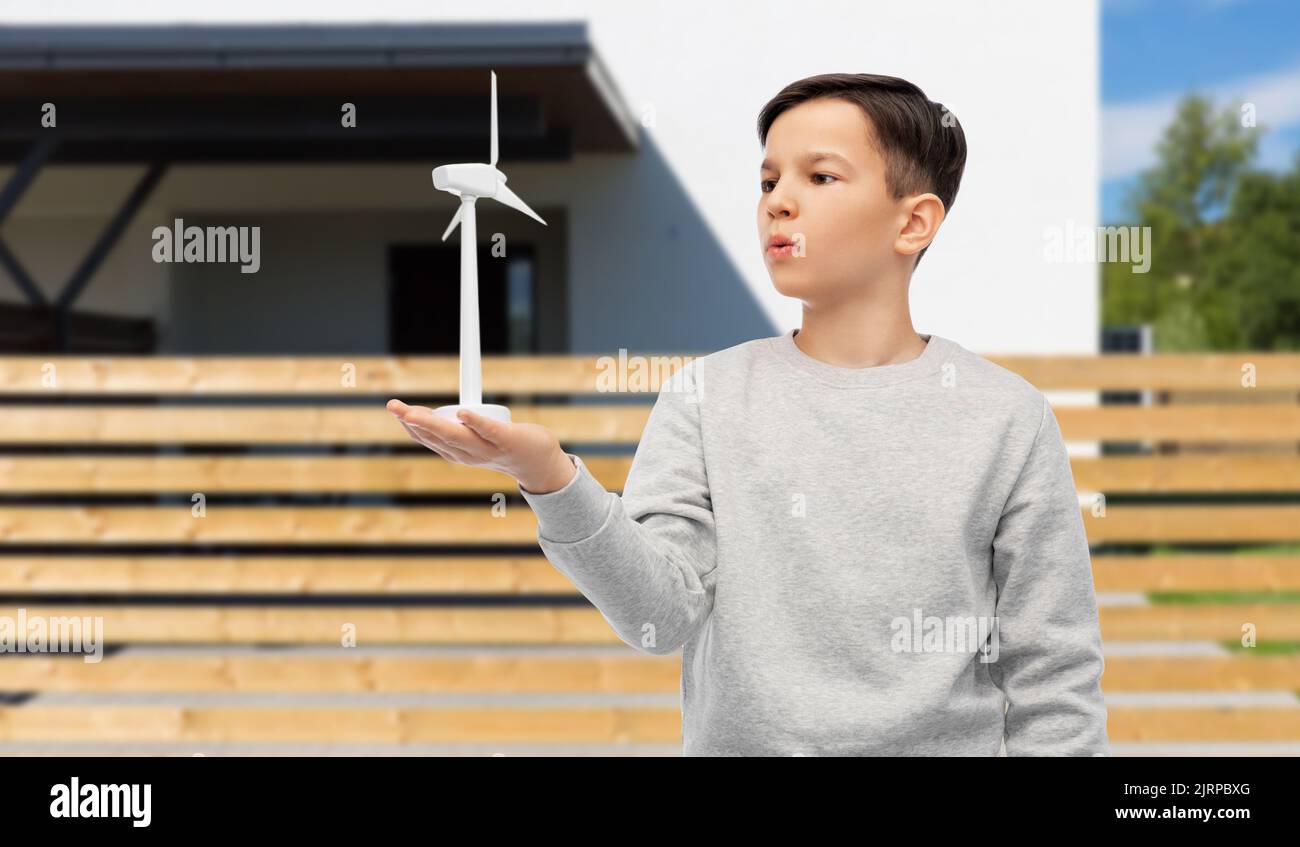 boy with toy wind turbine over house background Stock Photo - Alamy