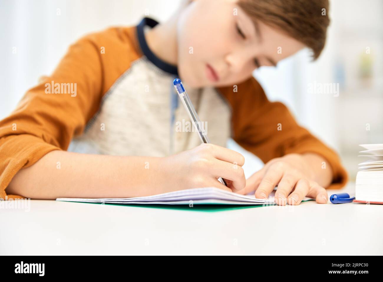 Teen boy writing book hi-res stock photography and images - Alamy