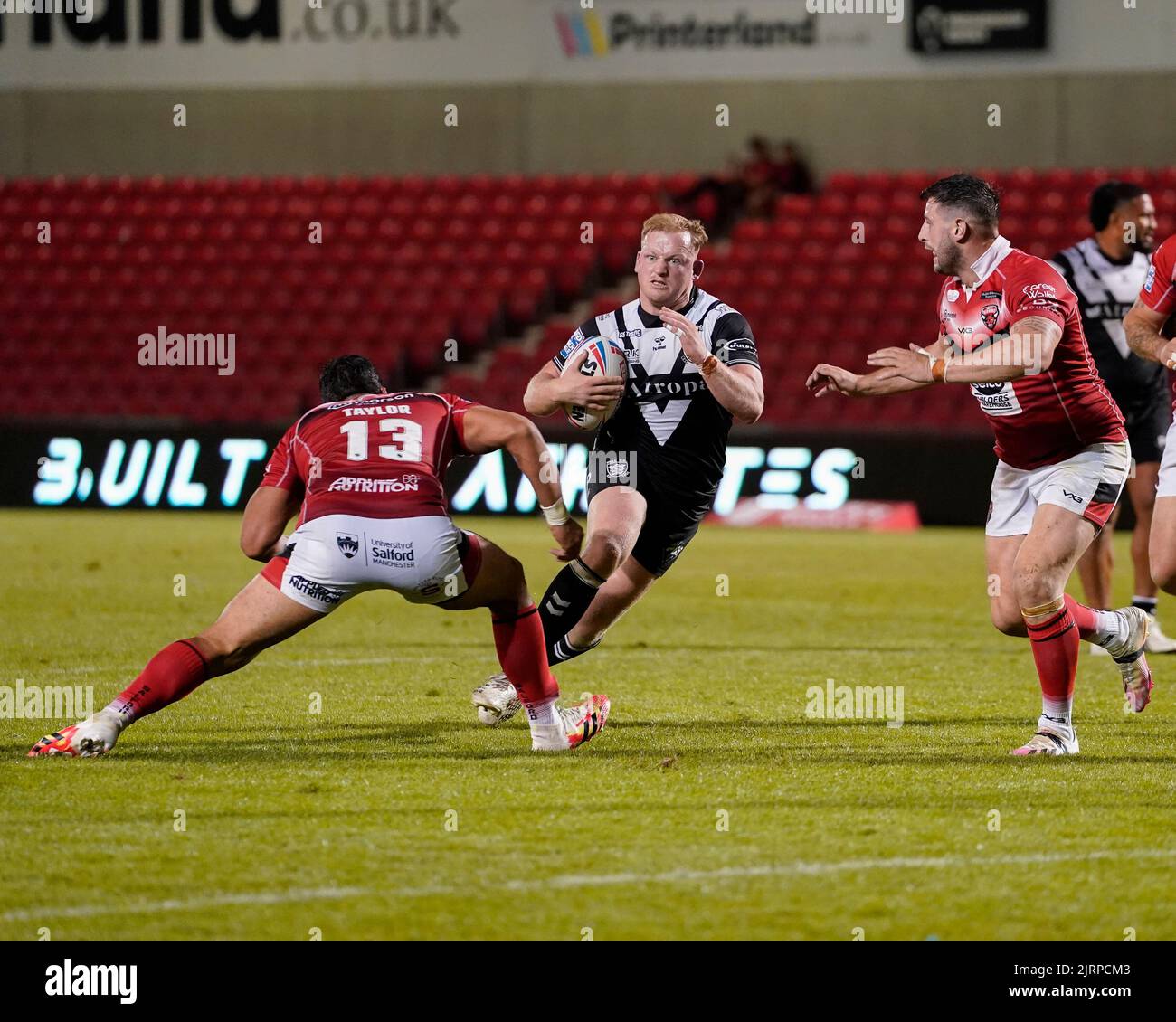 Jordan Johnstone #21 of Hull FC runs at Elijah Taylor #13 of Salford ...