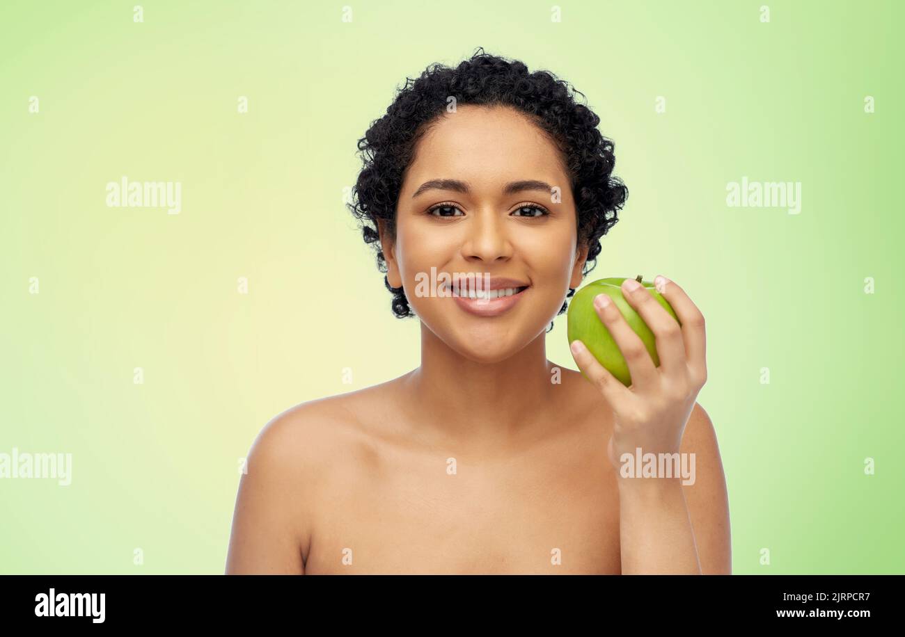 happy african american woman holding green apple Stock Photo - Alamy
