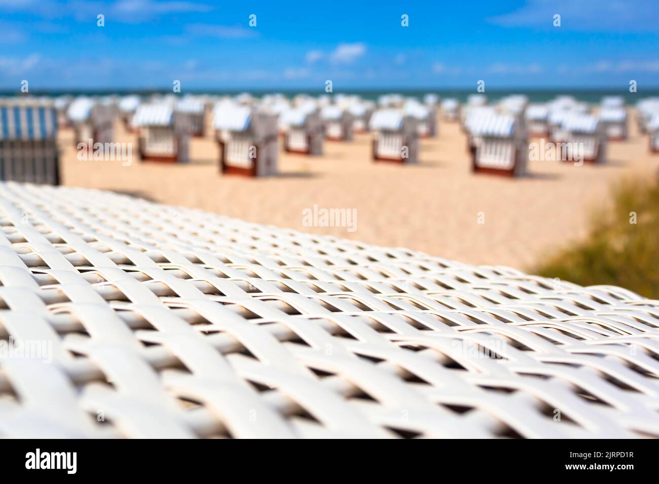 Detail braided white roof beach chair on foreground and defocused ...