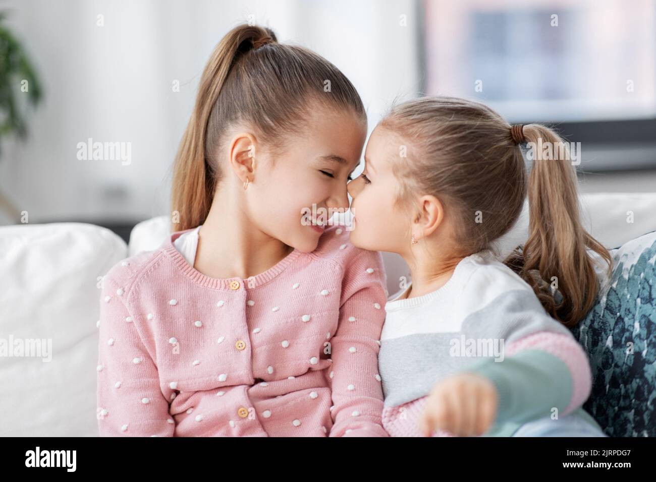 two happy smiling little girls or sisters at home Stock Photo - Alamy