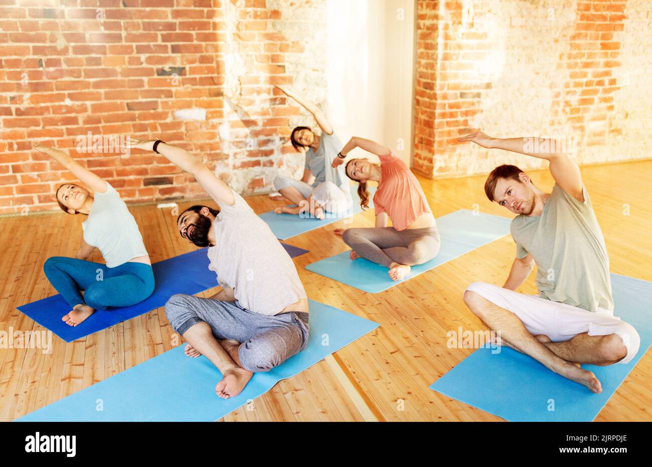 group of people doing yoga exercises at studio Stock Photo - Alamy