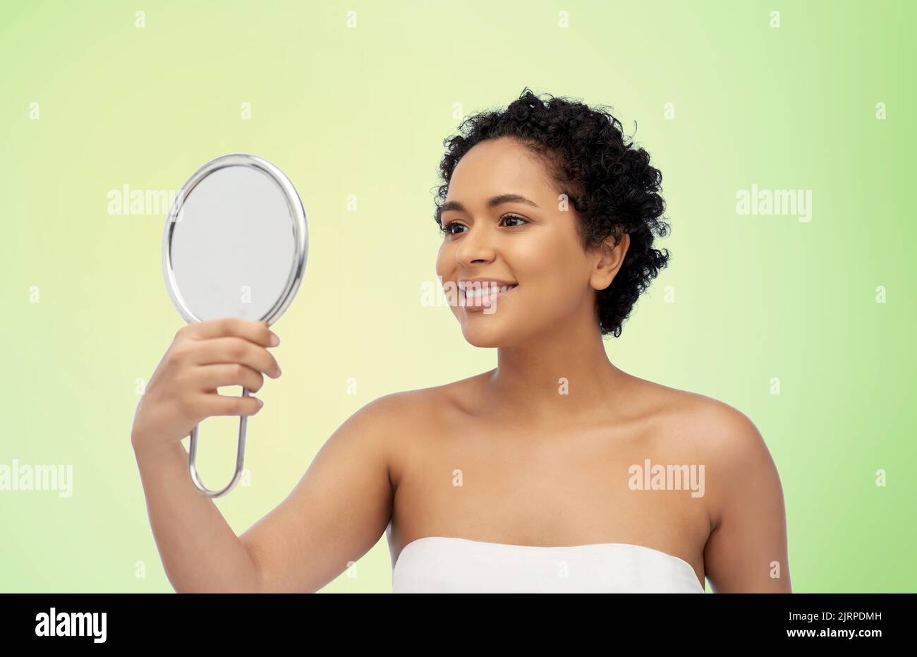 smiling african american woman looking to mirror Stock Photo - Alamy