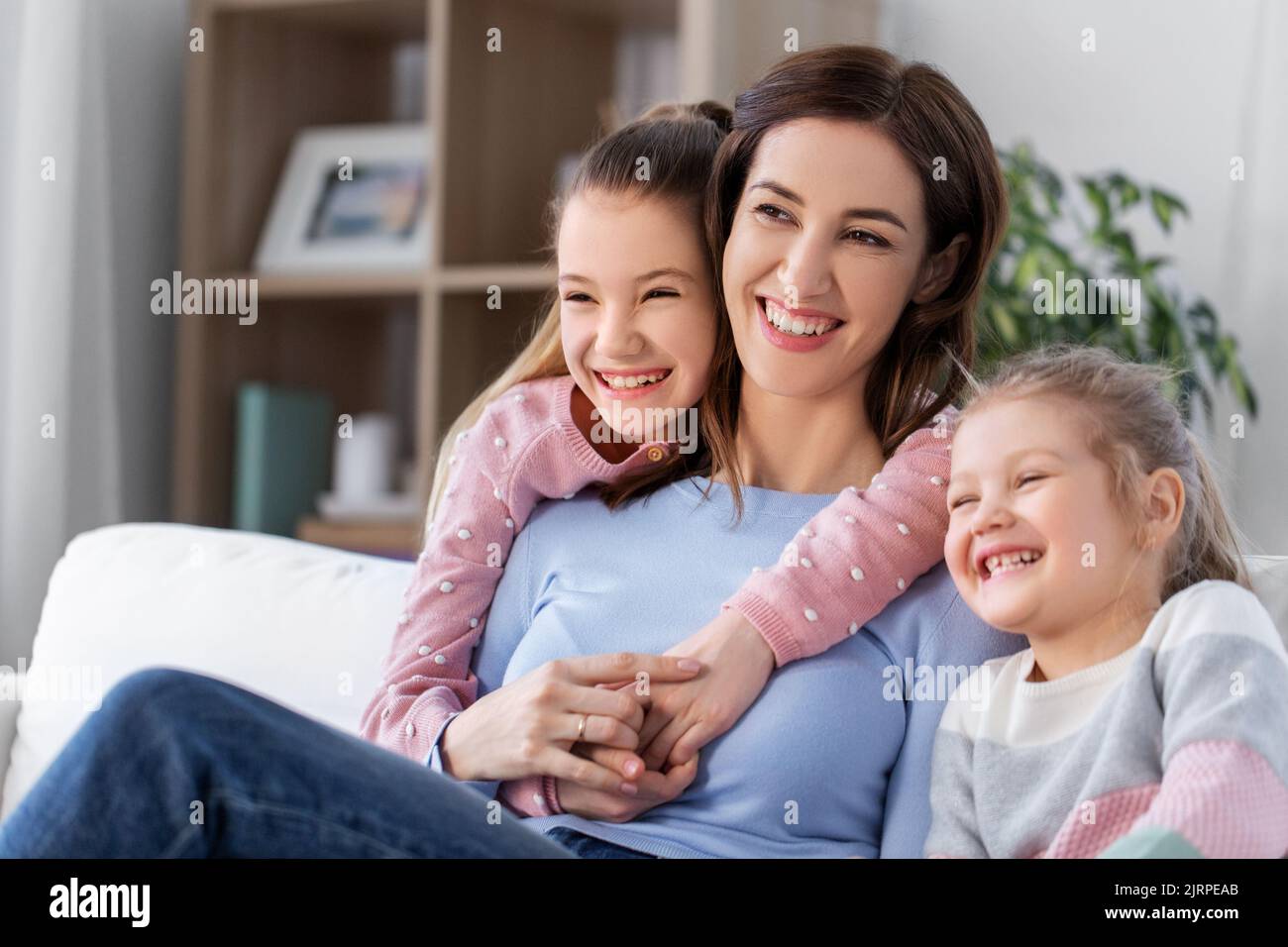Woman and embracing two daughters hi-res stock photography and images ...