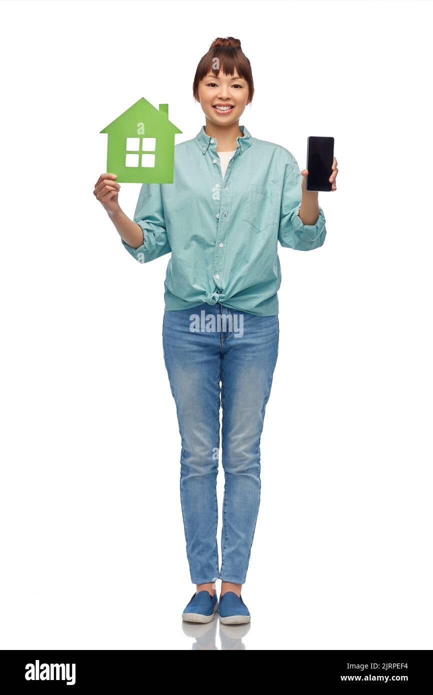 smiling asian woman holding green house Stock Photo - Alamy