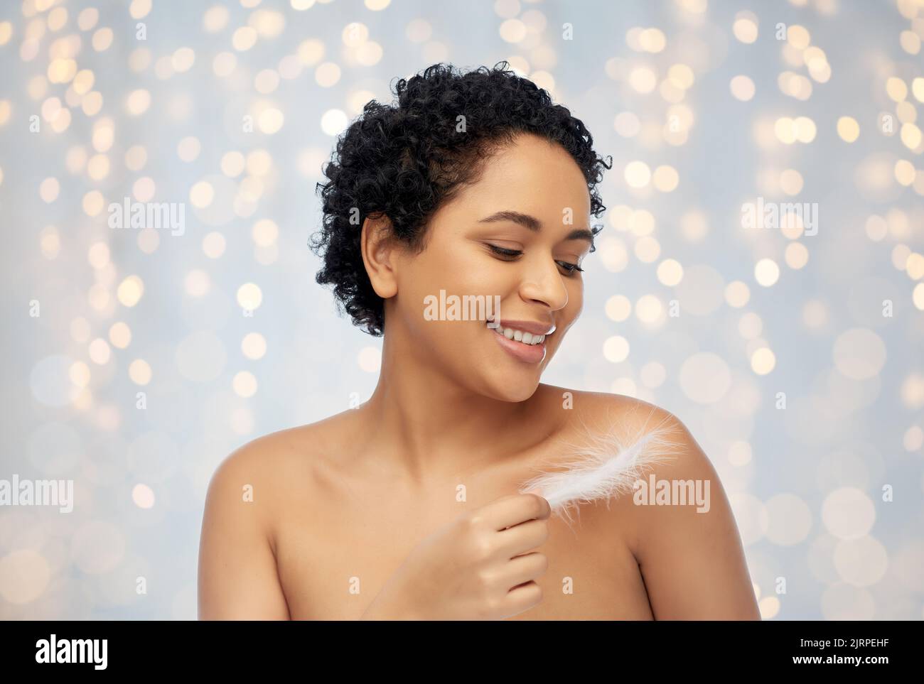 happy african american woman with feather Stock Photo - Alamy