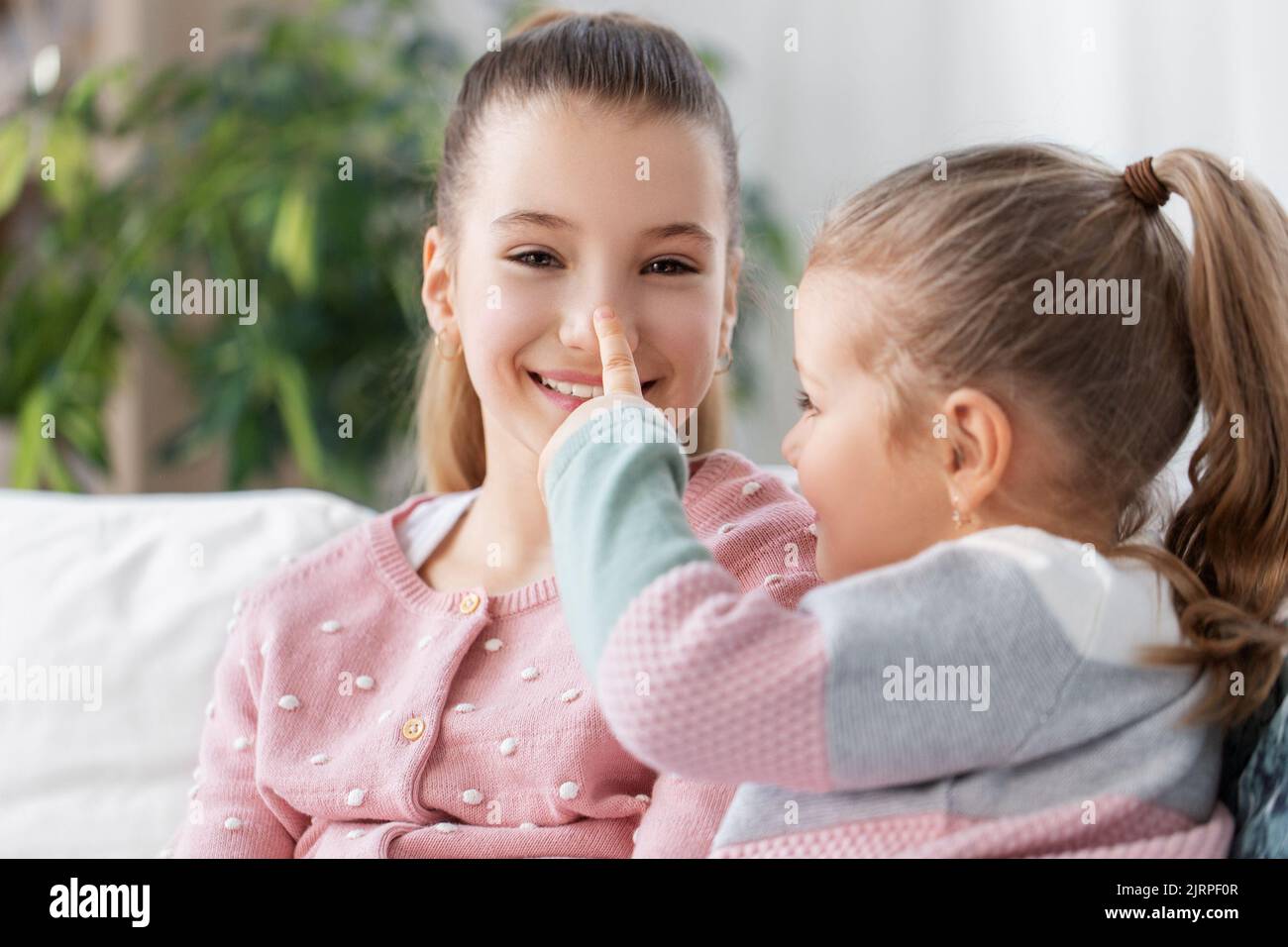 two happy smiling little girls or sisters at home Stock Photo - Alamy