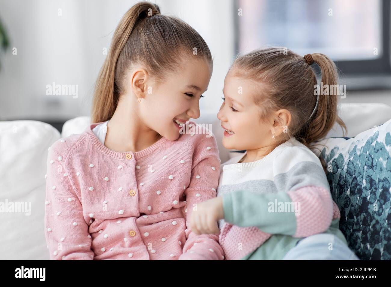 two happy smiling little girls or sisters at home Stock Photo - Alamy