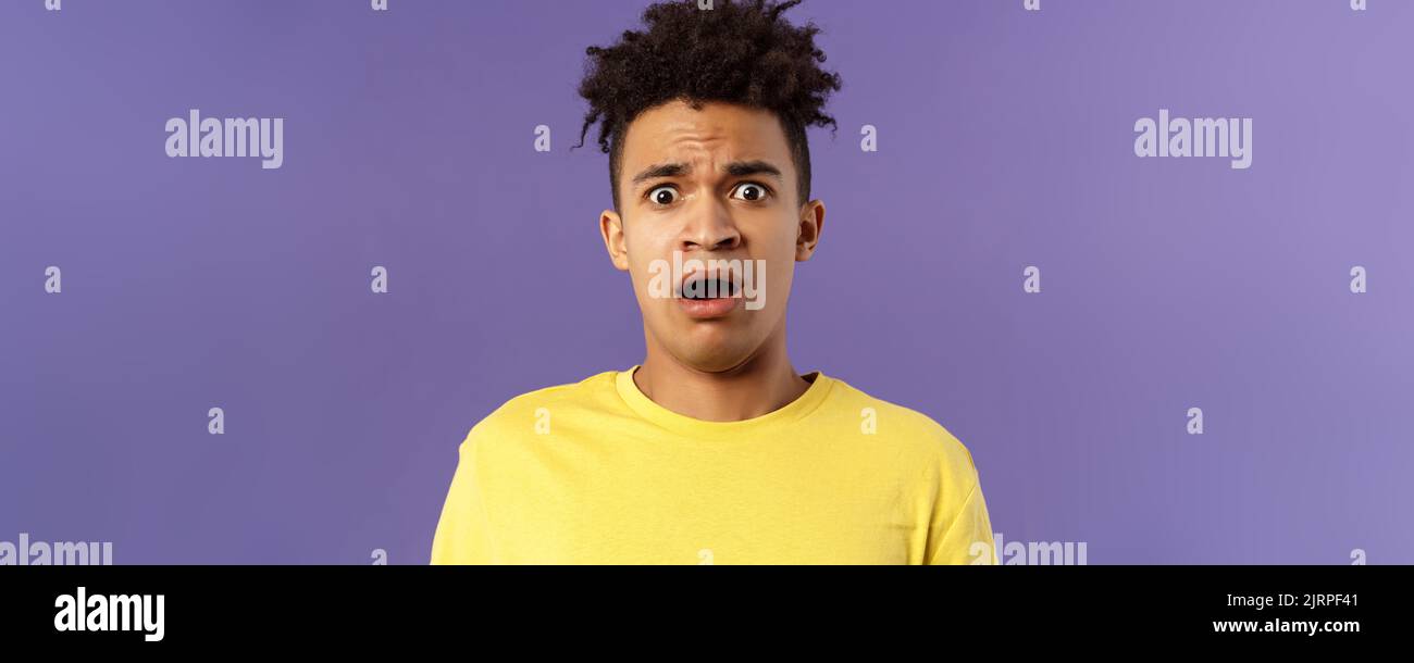 Close-up portrait of shocked, alarmed young man gasping, open mouth ...