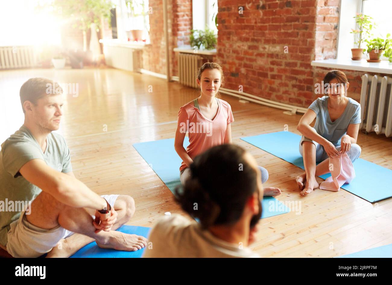 group of people resting on yoga mats at studio Stock Photo - Alamy