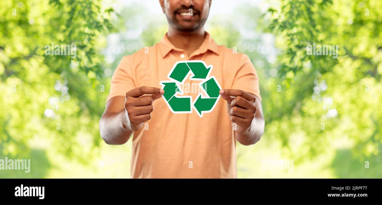 smiling indian man holding green recycling sign Stock Photo - Alamy