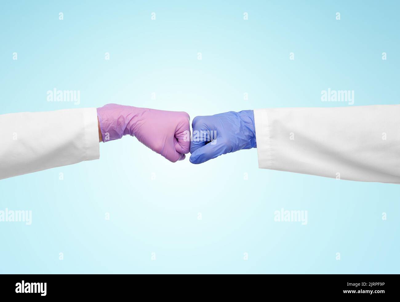 hands of doctors in gloves make fist bump gesture Stock Photo - Alamy