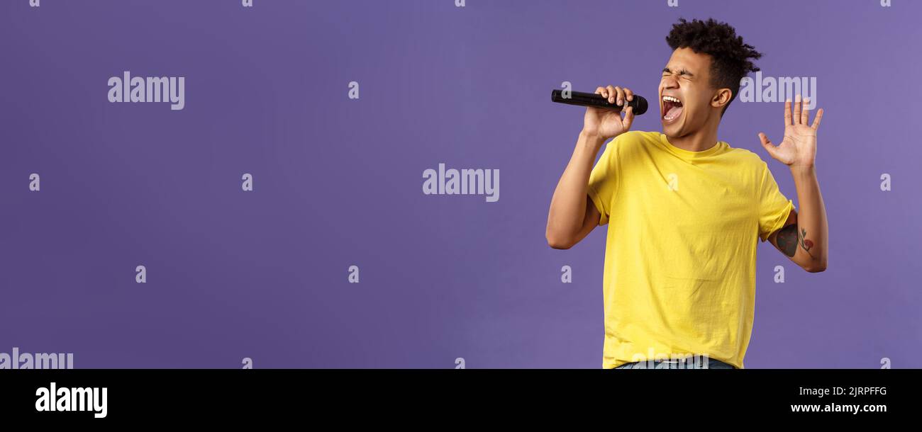 Portrait of passionate carefree young hispanic singer with dreads and ...