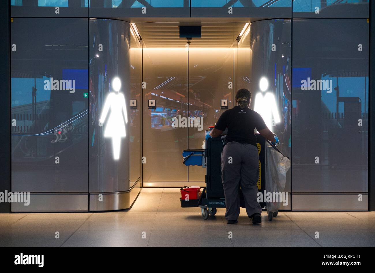 A cleaning lady prepares to enter and clean the ladies female loos ...