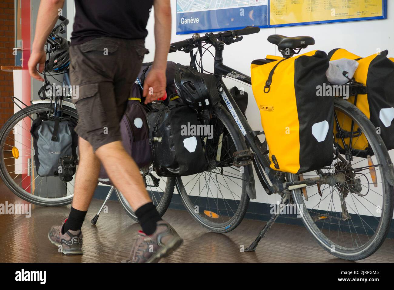 Two touring bicycles, heavily laden with cycle / bike panniers, left standing by their cycle ...