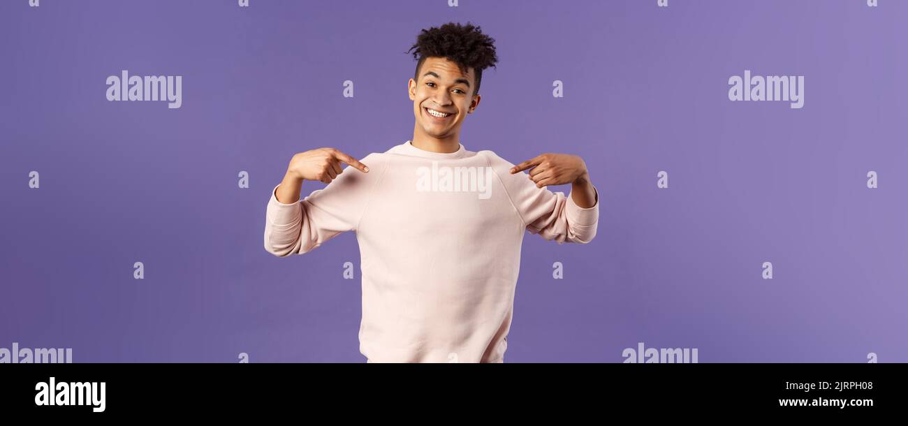 Cute and silly handsome male student pointing at himself and making ...