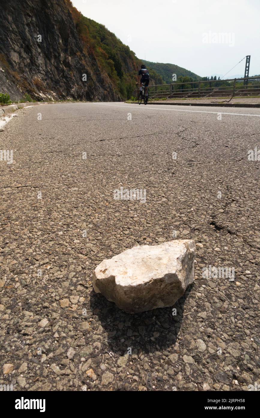 Fallen rock / cliff rocks on the road cause a hazard to car, drivers ...